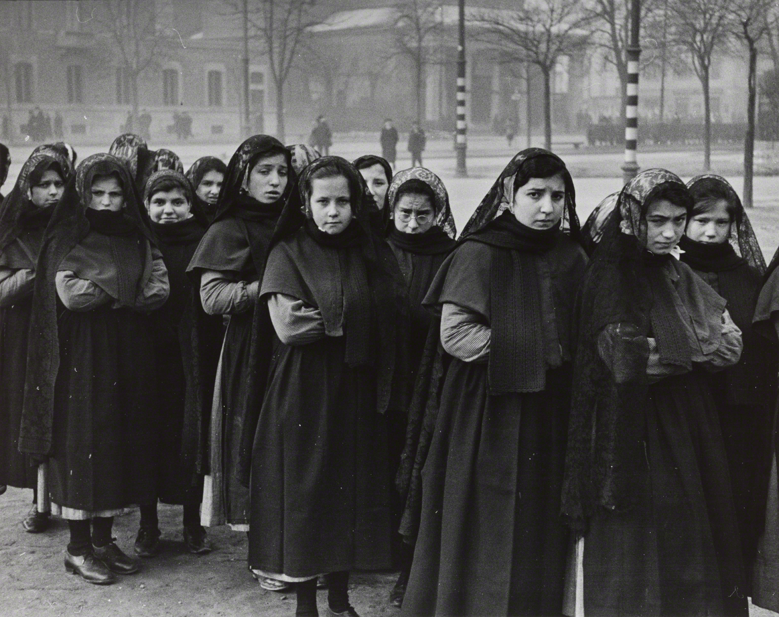 Young girls in uniforms with lace on heads looking at camera, Turin ...